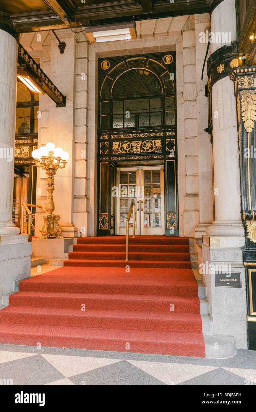 Visitors approach the main entrance featuring red carpet steps and ...