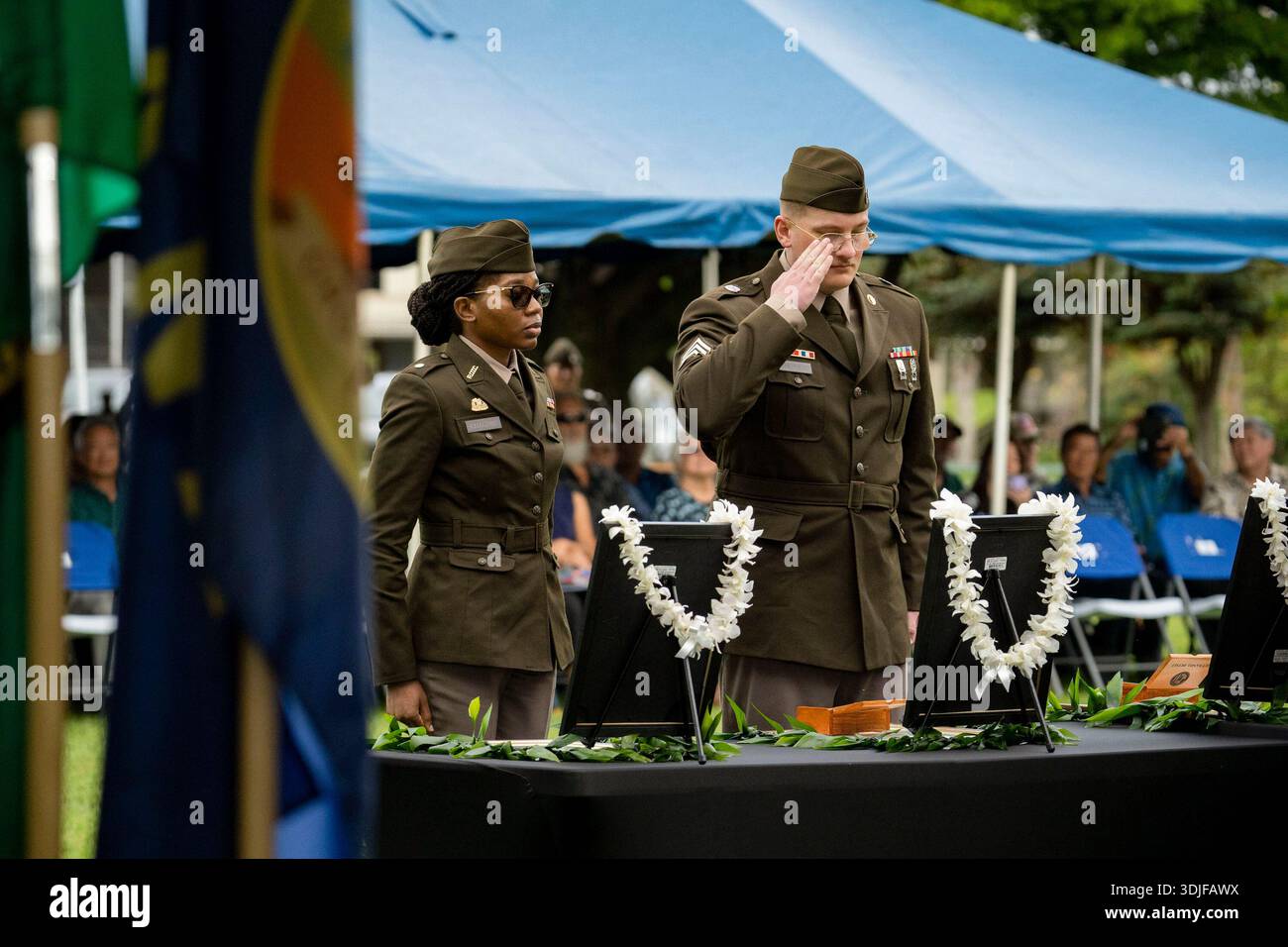U.S. Army soldiers salute framed photos of former University of Hawaii ...