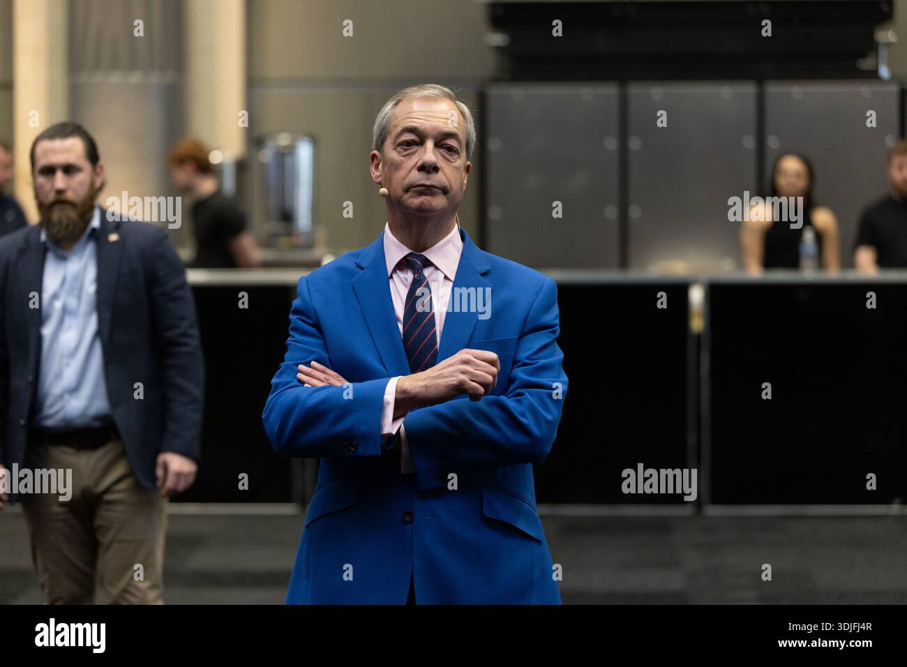Reform UK leader Nigel Farage waits off stage prior to his speech at a ...