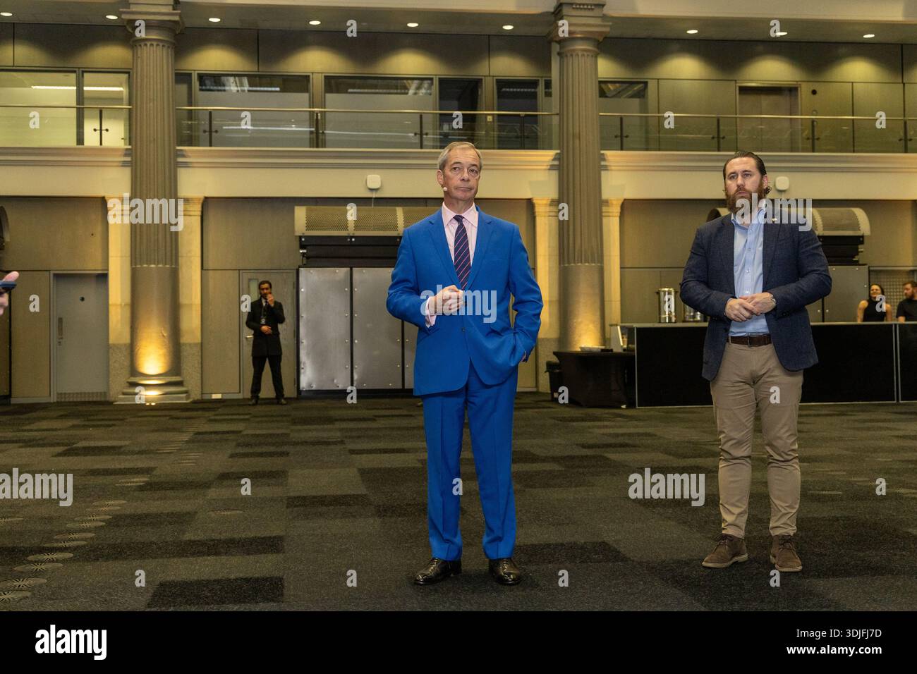 Reform UK leader Nigel Farage waits off stage prior to his speech at a ...