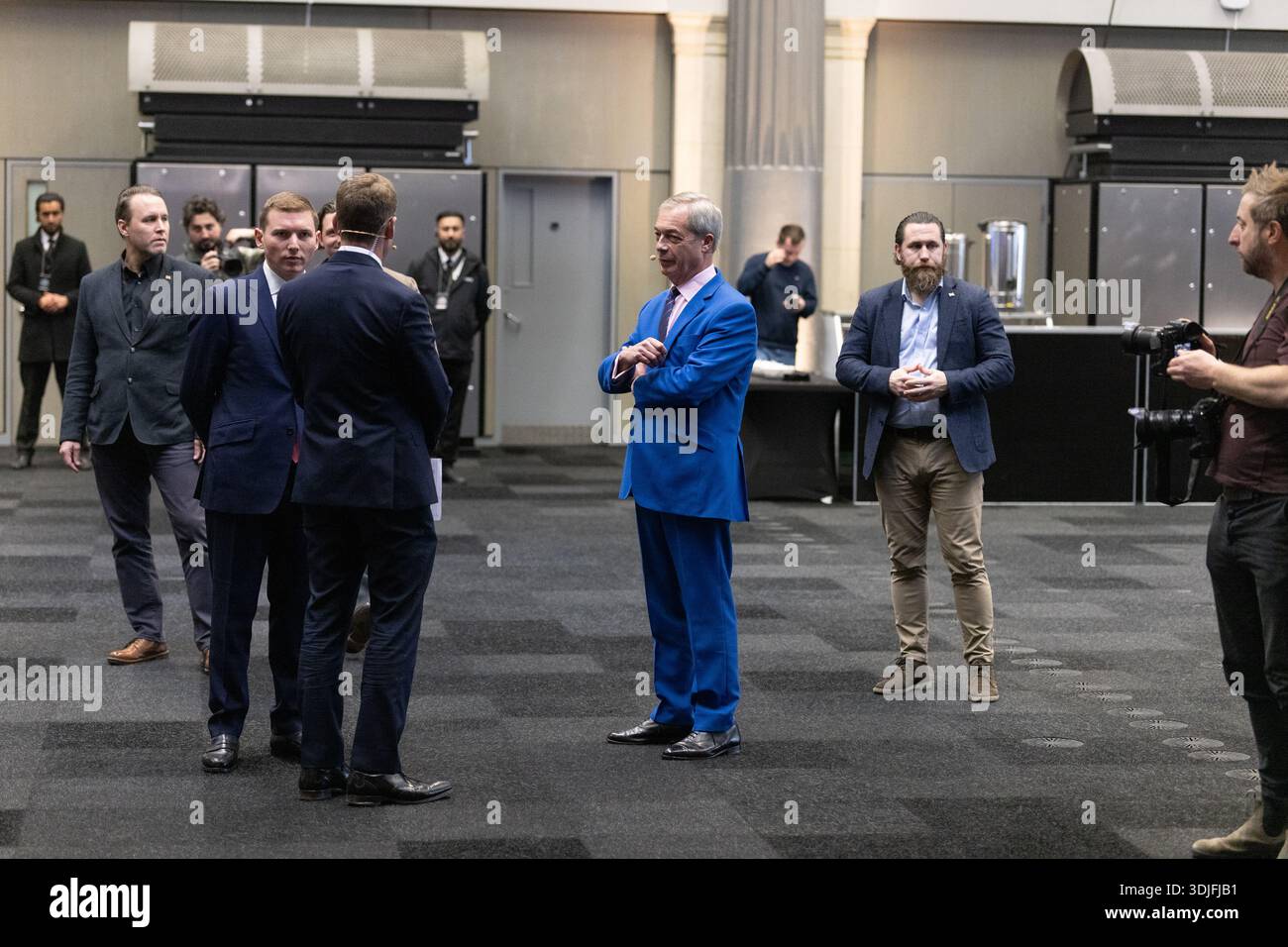 Reform UK leader Nigel Farage waits off stage prior to his speech at a ...