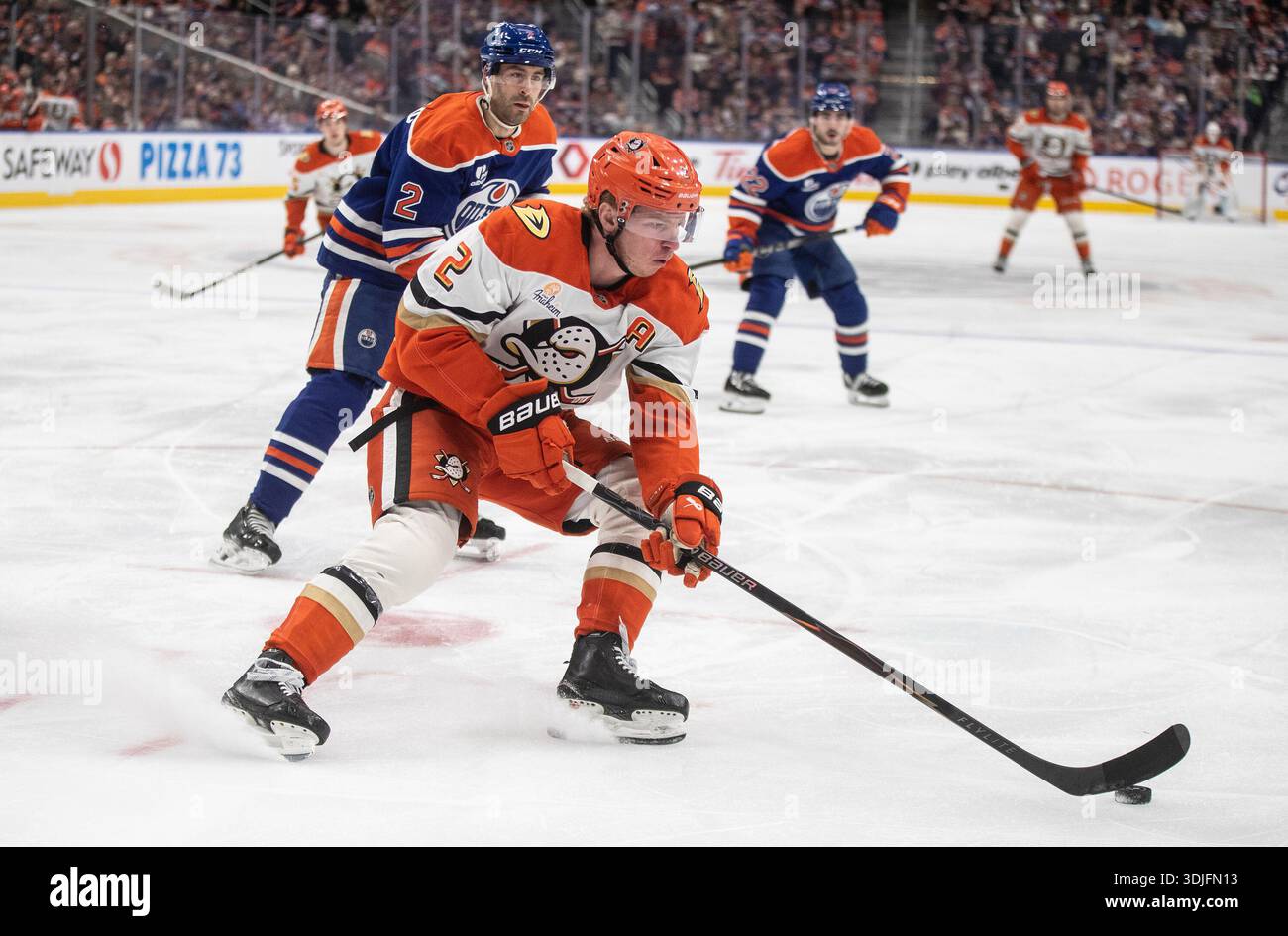 Anaheim Ducks' Jackson LaCombe, front,is chased by Edmonton Oilers ...