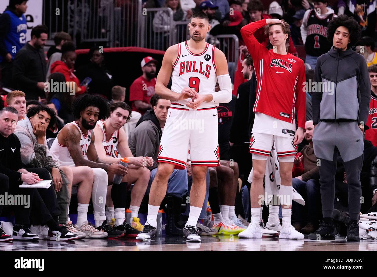Chicago Bulls watch the second half of an NBA basketball game against ...