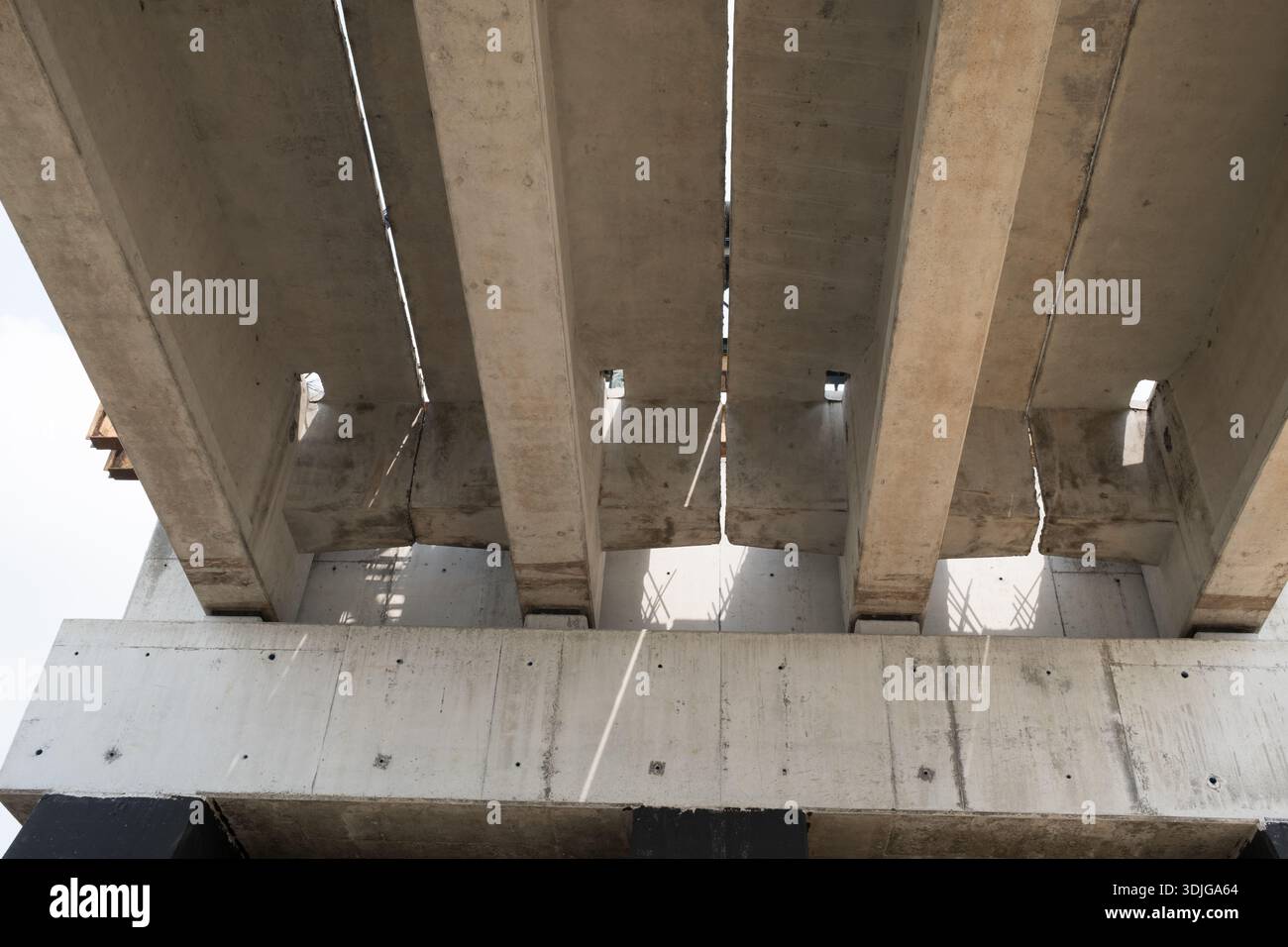 Close-up underside view of a concrete bridge under construction showing ...