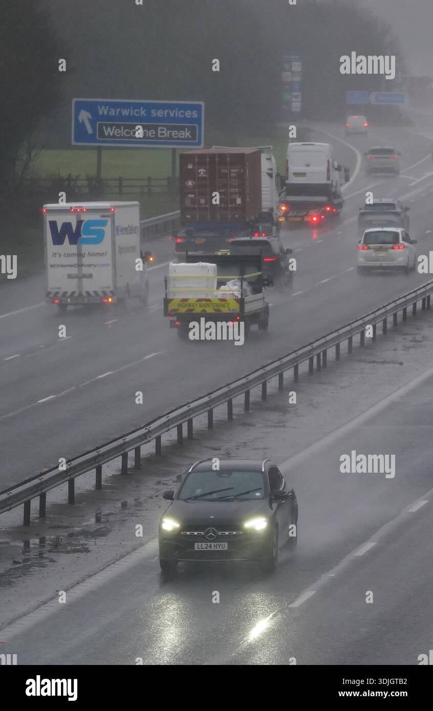 Vehicles drive through the rain on the M40 motorway near Warwick. Storm ...