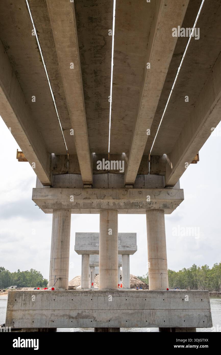 Underside view of a concrete bridge under construction with reinforced ...