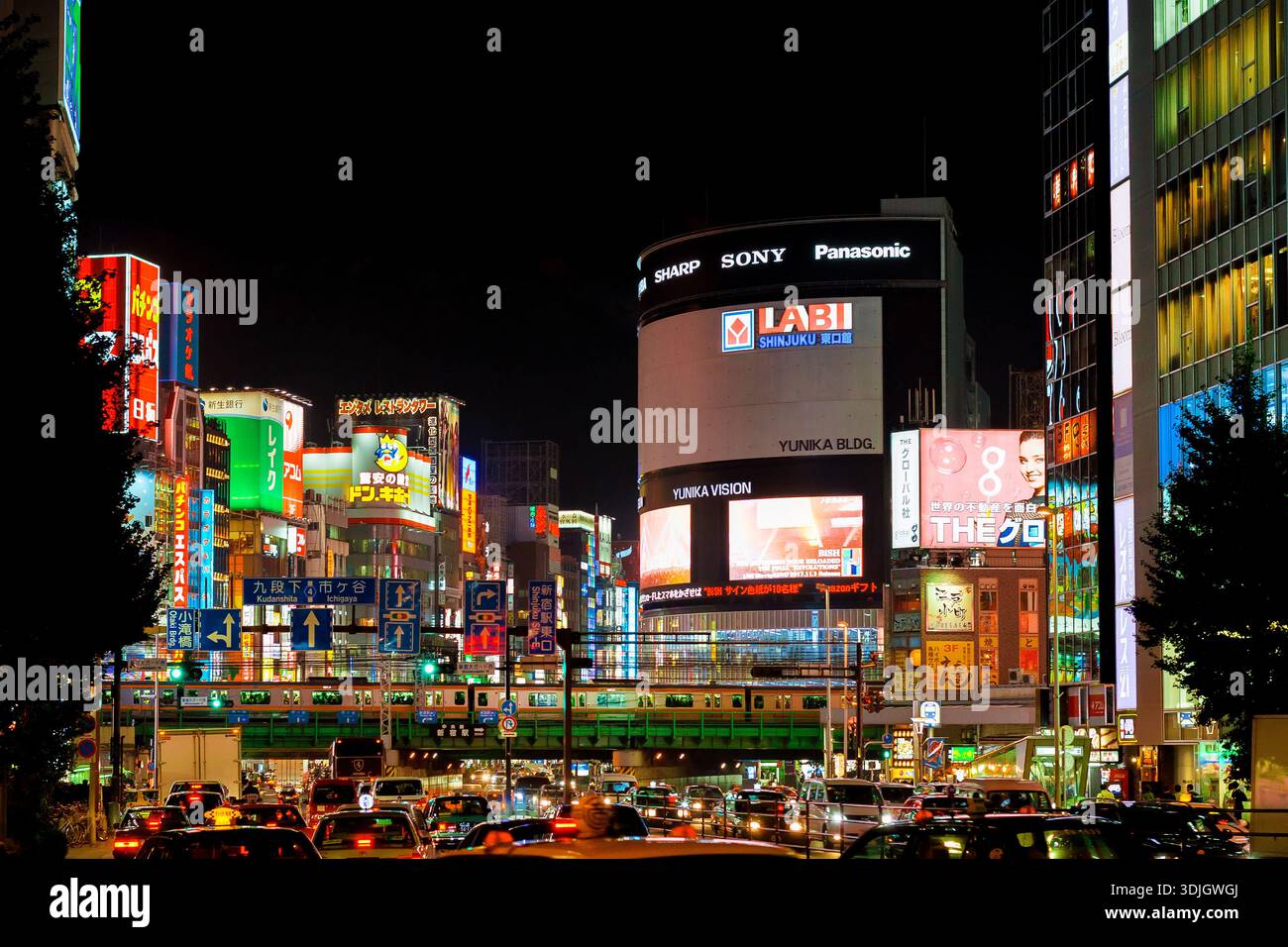 Night in Tokyo. View of Shinjuku city lights and Yamanote Line train ...