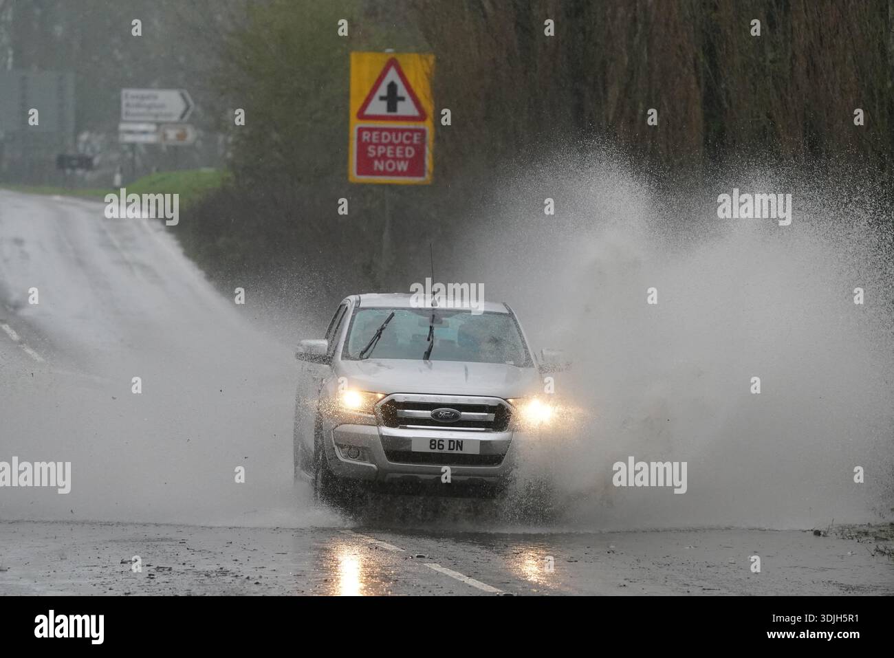 A vehicle driving through the pooled rainwater on the A20 in Ashford ...