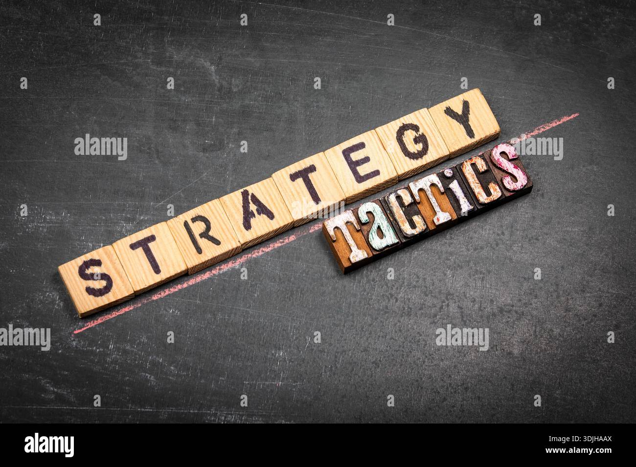 STRATEGY and TACTICS contrasted with wooden letter blocks illustrating ...