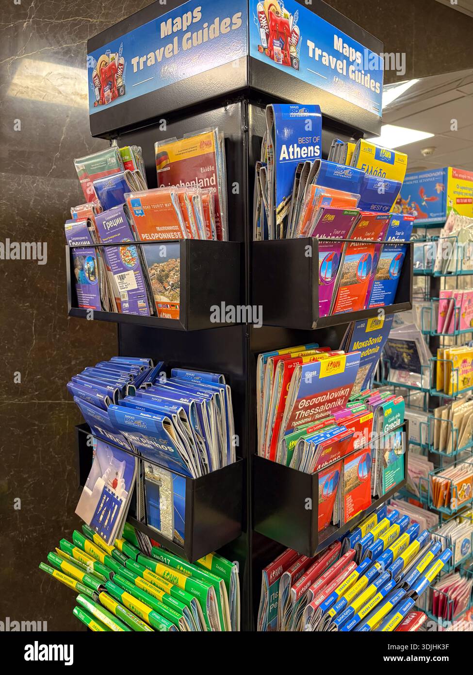 Retail display stand featuring folded paper maps and travel guides for ...
