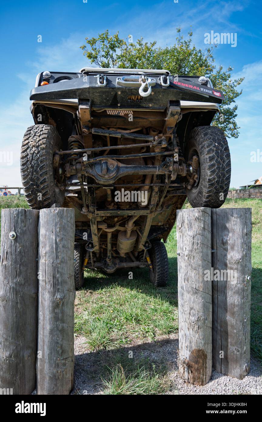 Underside detail of a Land Rover Defender TD5 4x4, elevated on wooden ...