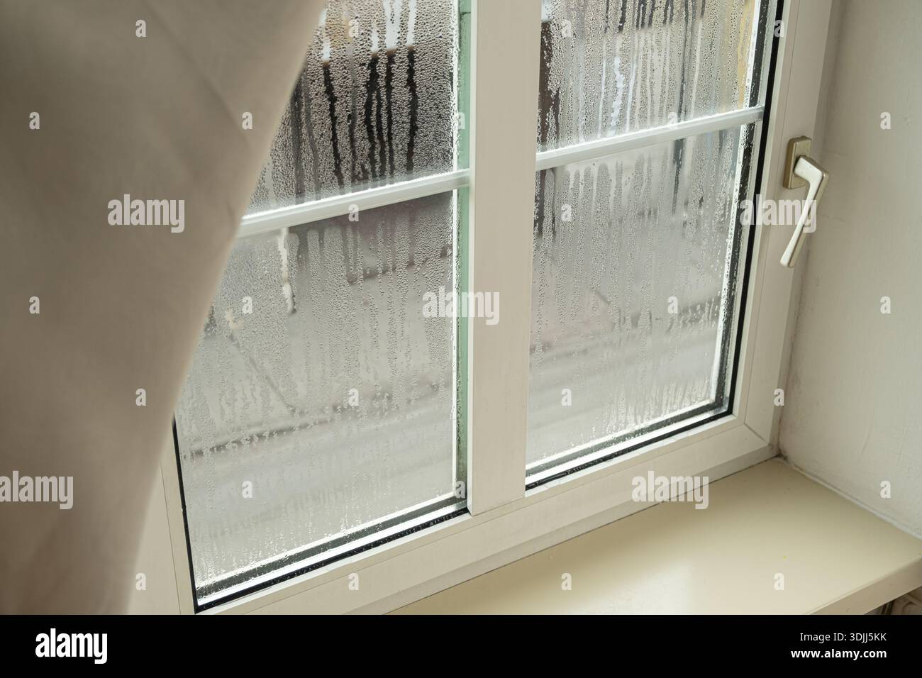 Plastic window with heavy condensation and water droplets. Indoor ...