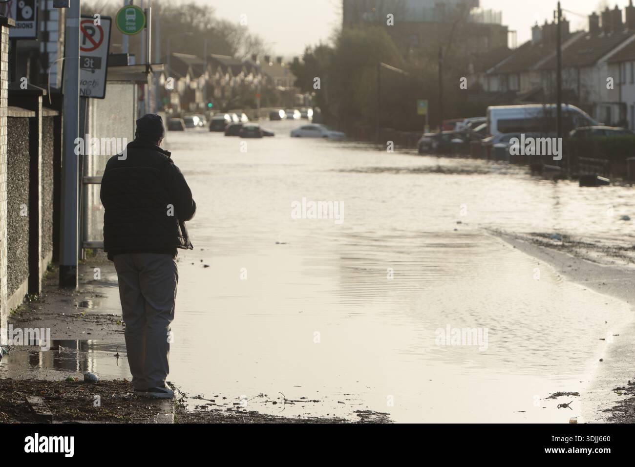 Dublin, Ireland - 27th January 2026: A man stands near a bus stop on a ...