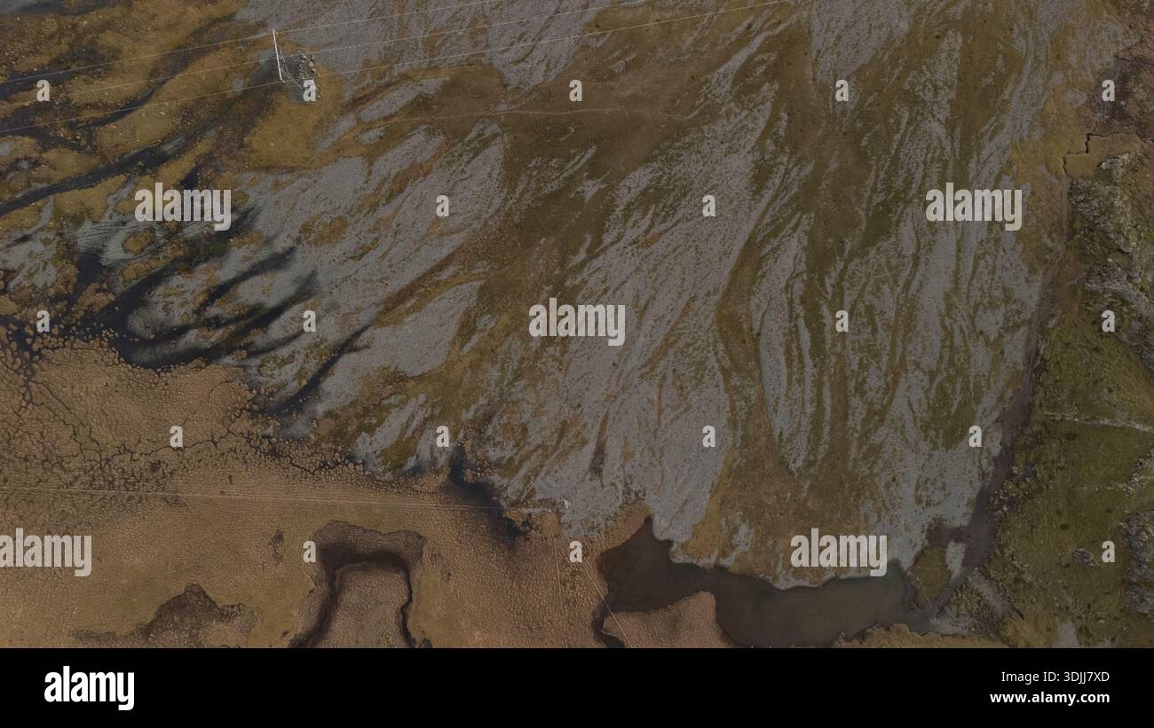 Aerial view of a rugged landscape where stone meets marshland, creating ...