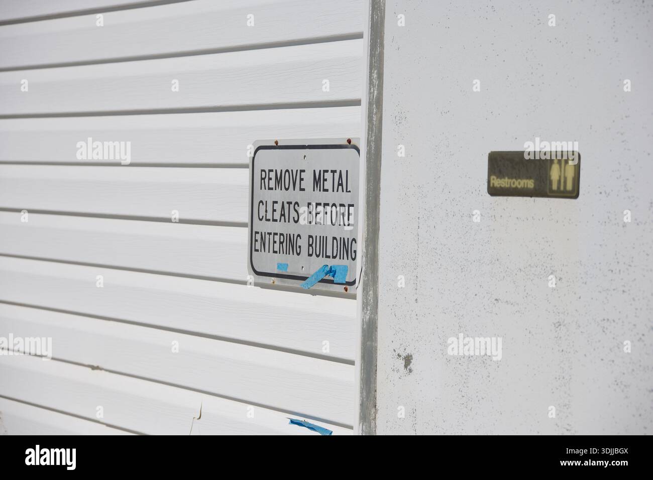 Remove Metal Cleats Before Entering Building Sign On White Siding Near ...