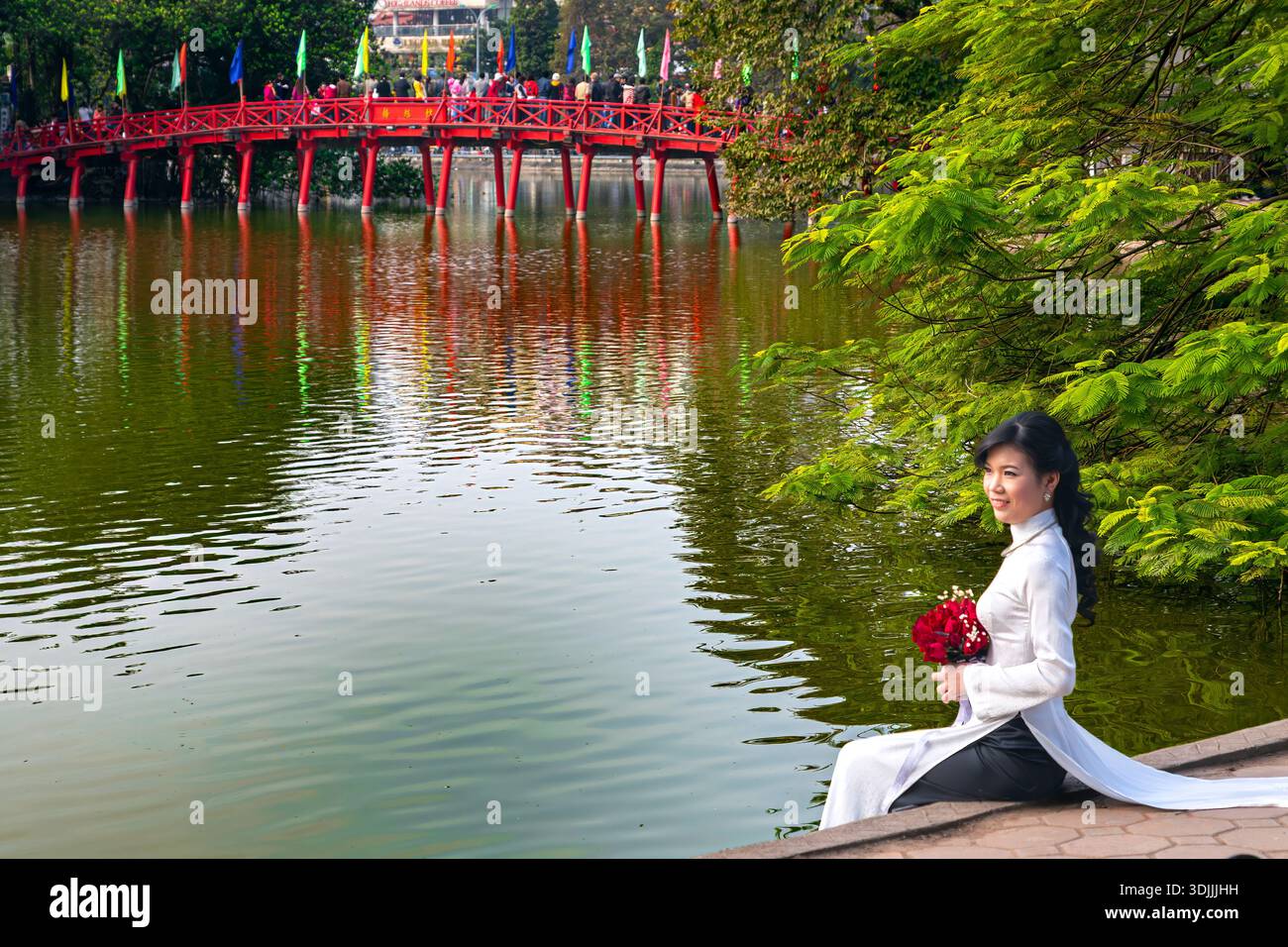 Attractive Vietnamese bride wearing traditional white silk ao dai and ...