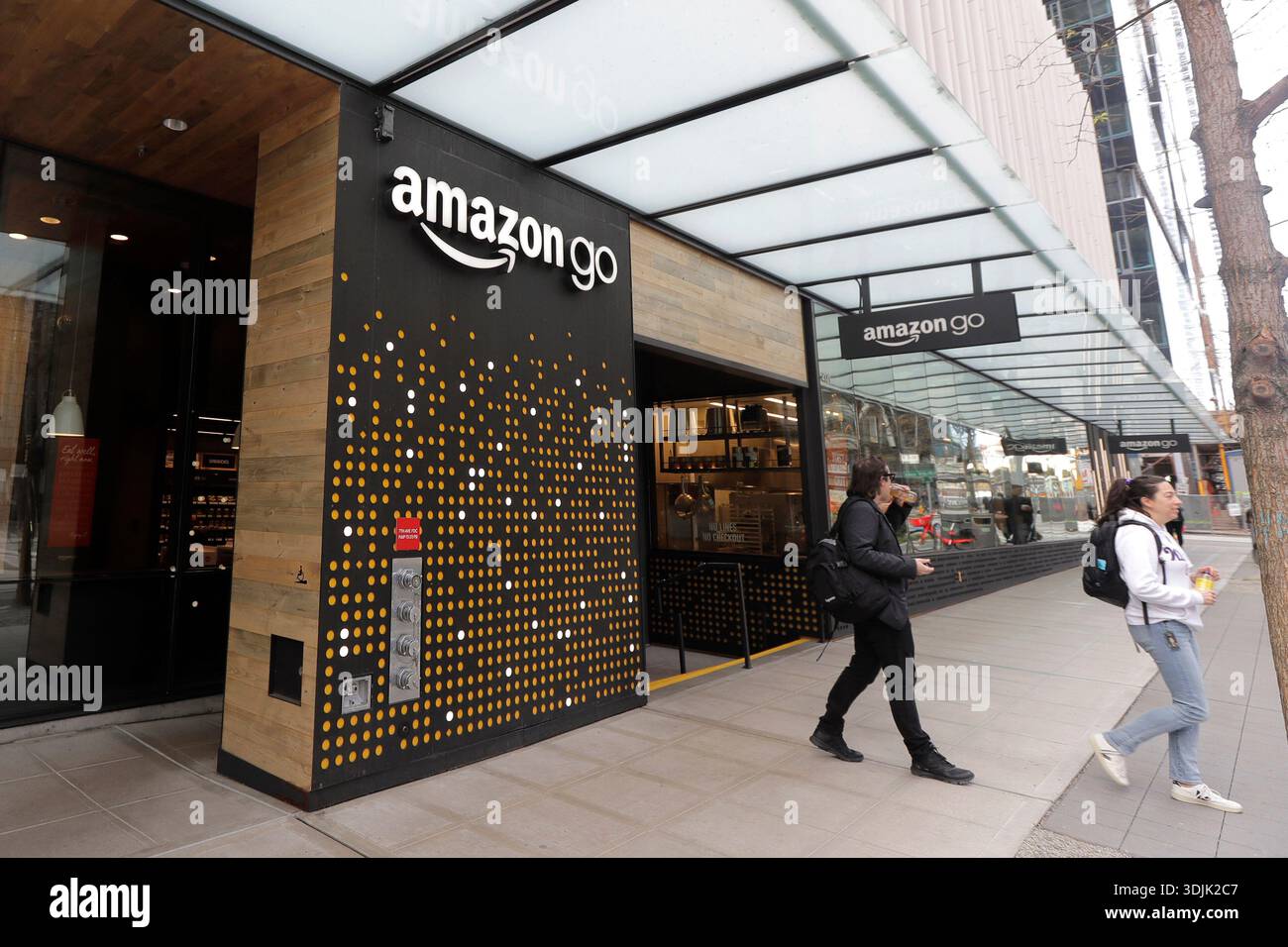 FILE - People walk out of an Amazon Go store in Seattle, March 4, 2020 ...