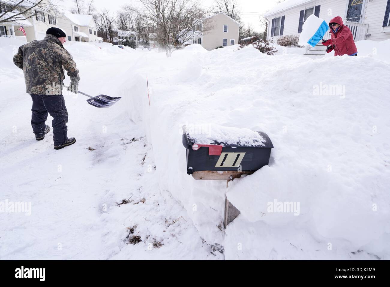 Todd Thibaud, left, and his wife Susan dig out their driveway and ...