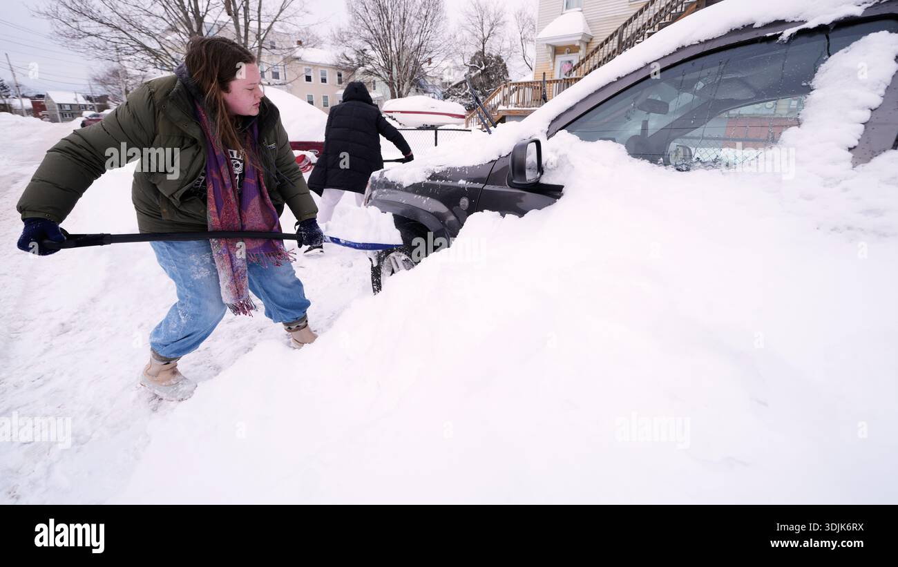 Emma Teske shovels out her car following a winter storm that dumped ...