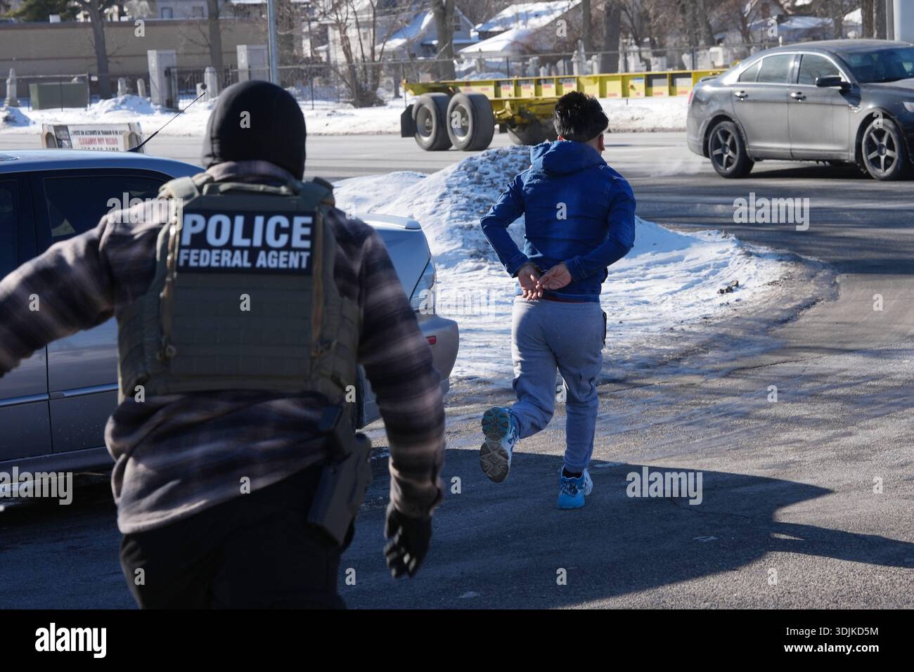 A man in handcuffs runs to avoid being detailed by federal immigration ...