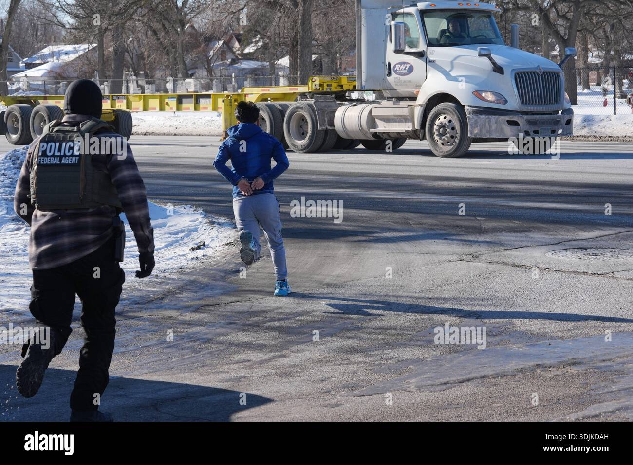 A man in handcuffs runs to avoid being detailed by federal immigration ...