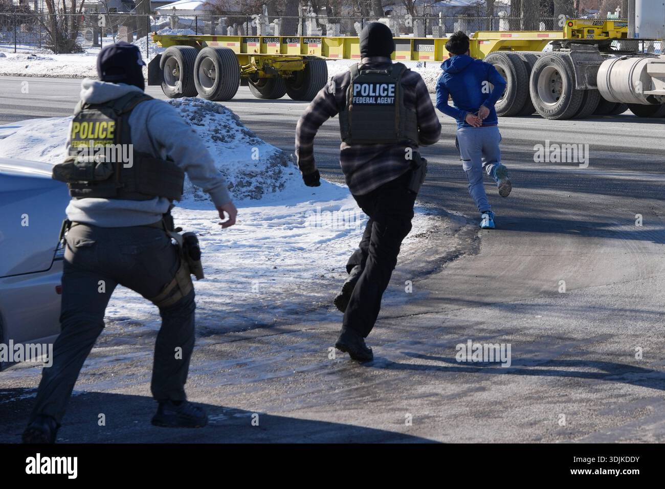A man in handcuffs runs to avoid being detailed by federal immigration ...