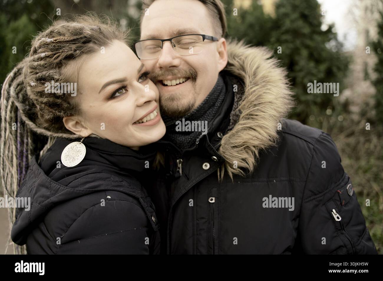 Perky passion, a couple laughing together while embracing, showcasing ...