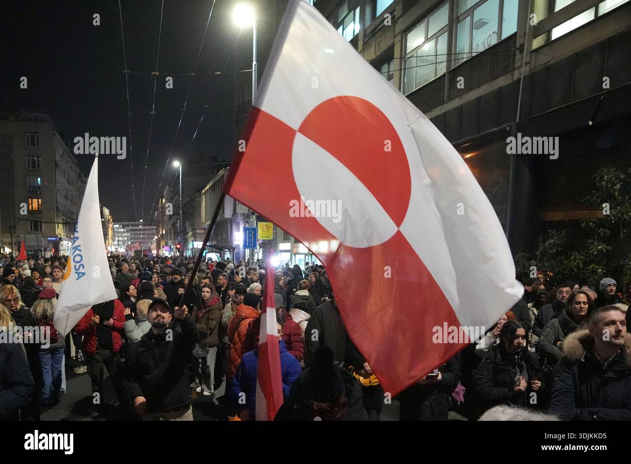 A man waves a Greenland flag during a protest against a government ...