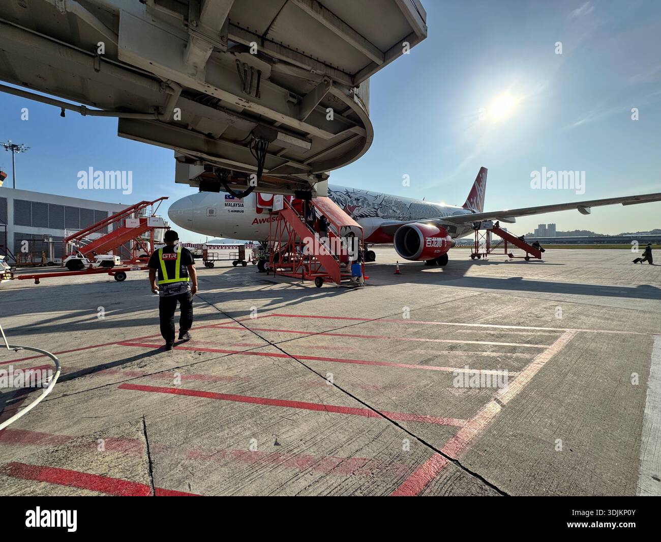 Penang, Malaysia - January 25, 2026 : Passengers board an AirAsia ...