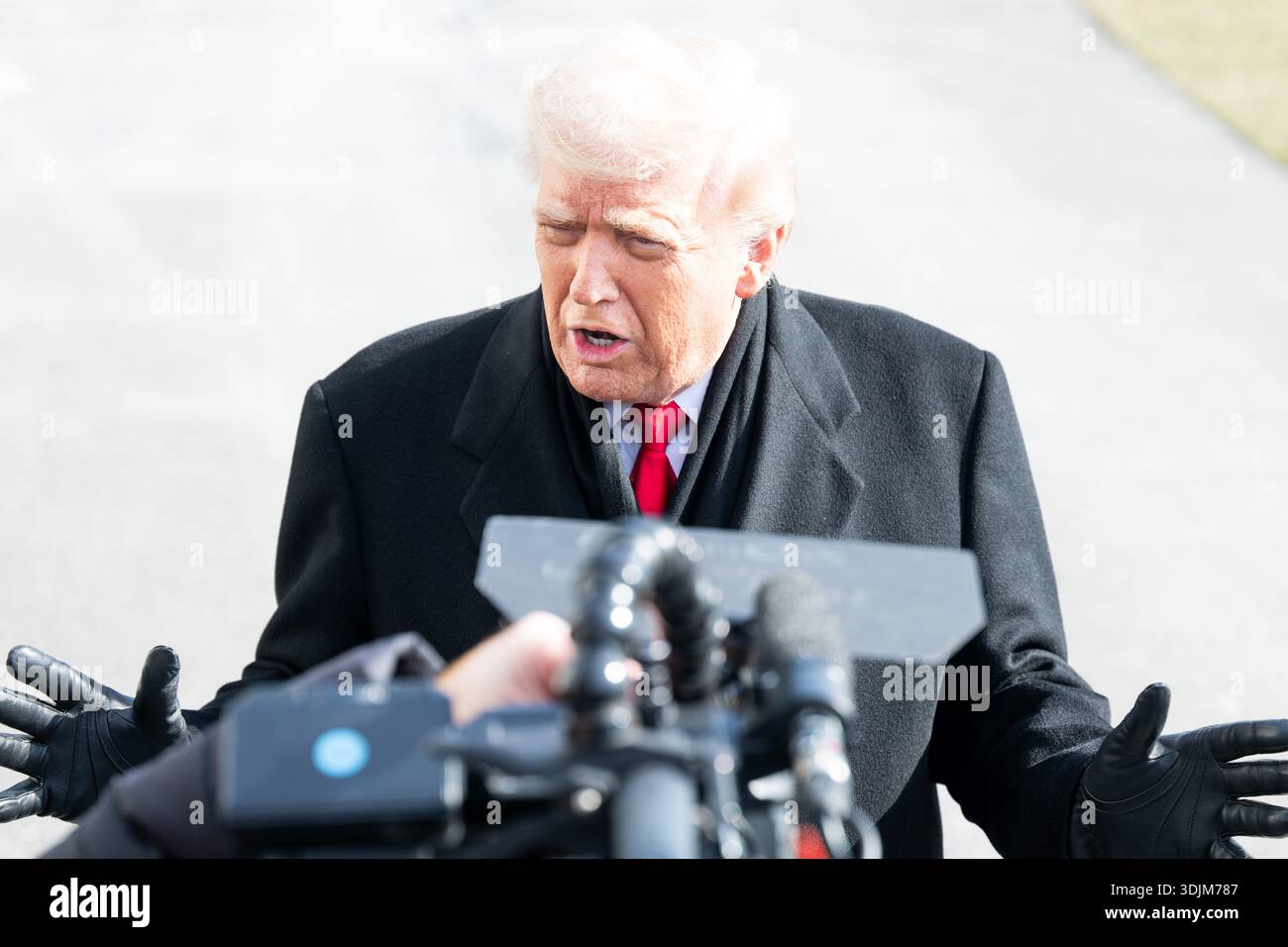 President Donald Trump talking with reporters as he leaves the White ...