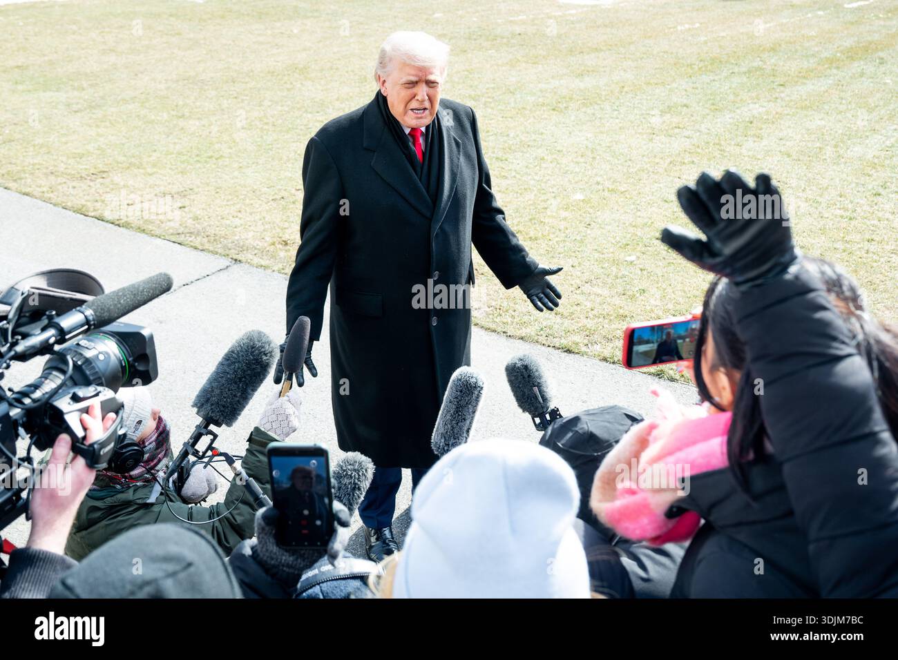 President Donald Trump talking with reporters as he leaves the White ...