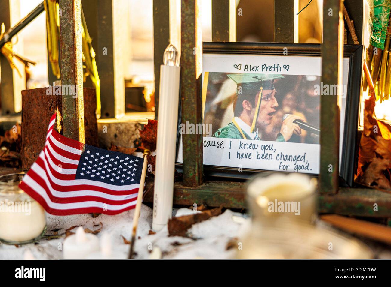 A framed photograph of Alex Pretti, along with candles and an American ...
