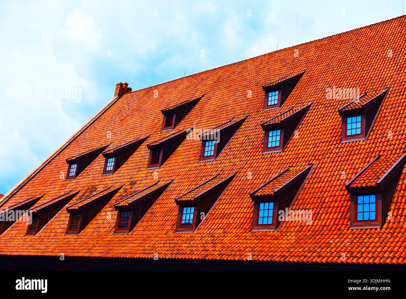 Steeply pitched, red-tiled roof of the Great Mill in Gdańsk, Poland ...