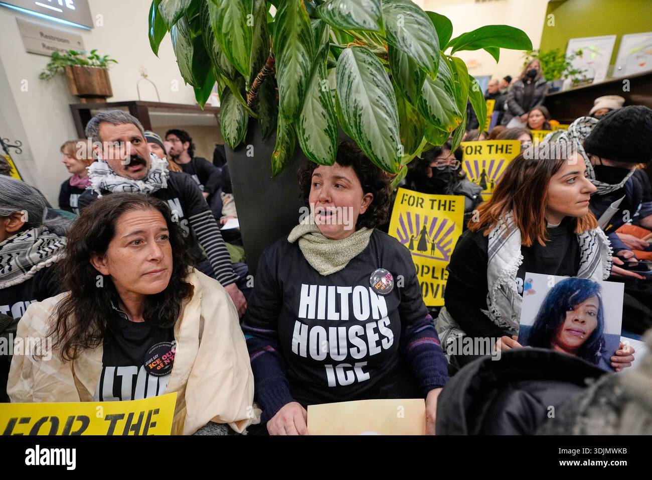 Protesters stage a sit-in in the lobby of a Hilton Garden Inn in New ...