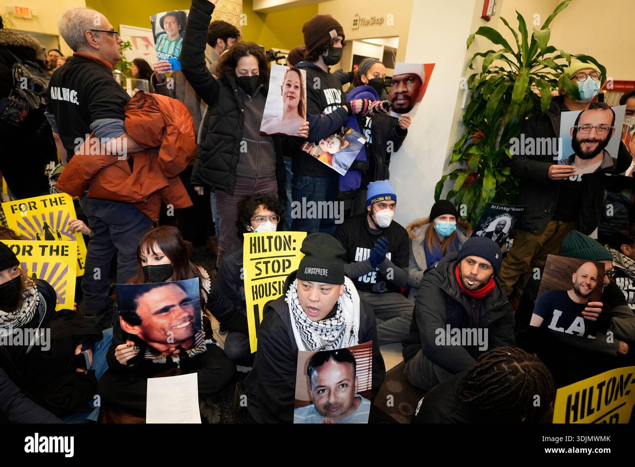 Protesters stage a sit-in in the lobby of a Hilton Garden Inn in New ...