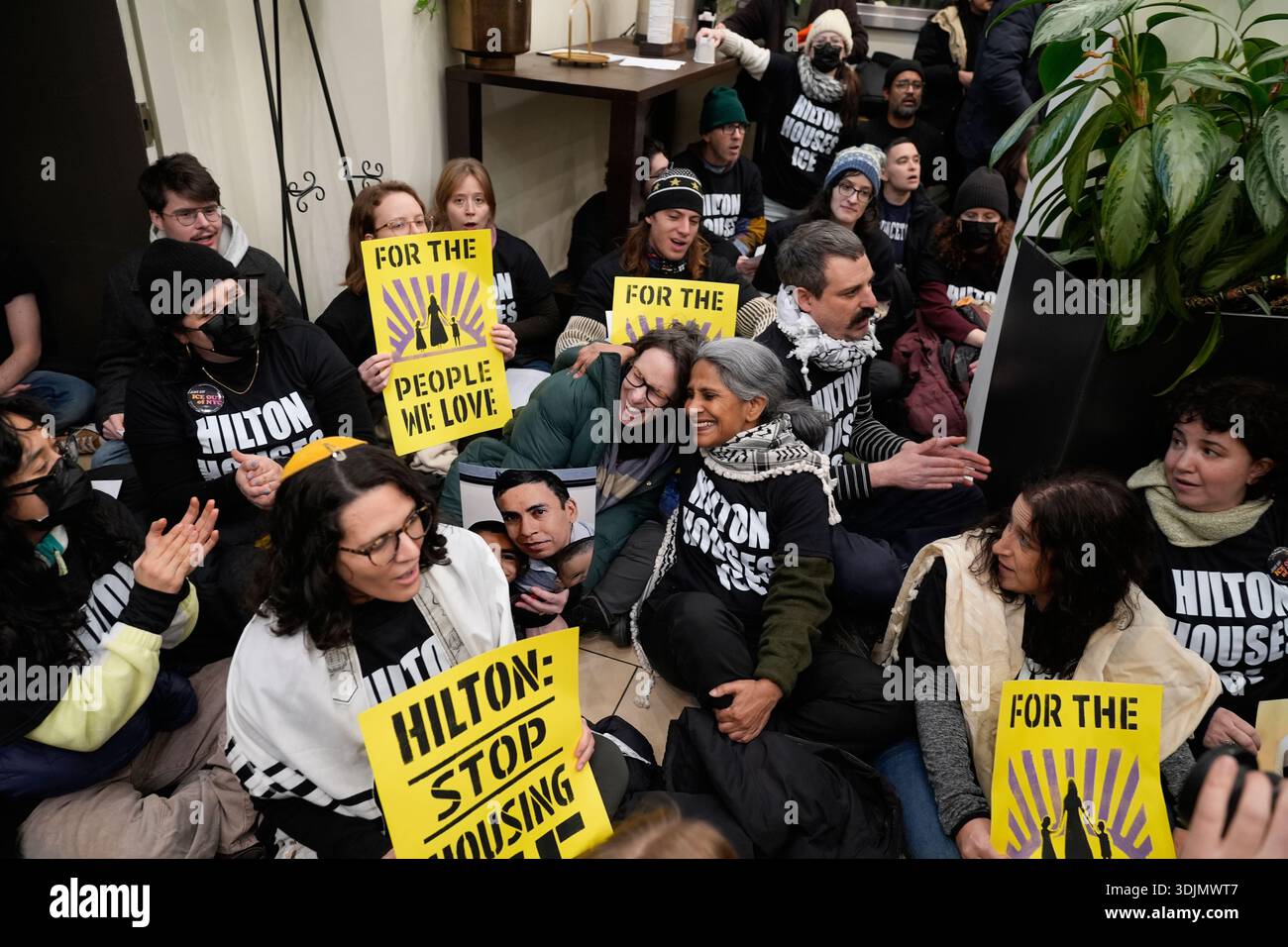 Protesters stage a sit-in in the lobby of a Hilton Garden Inn in New ...