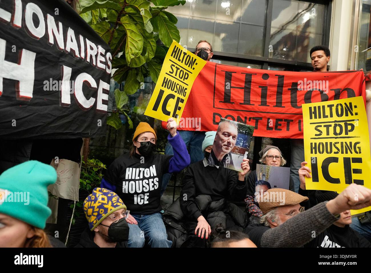 Protesters stage a sit-in in the lobby of a Hilton Garden Inn in New ...