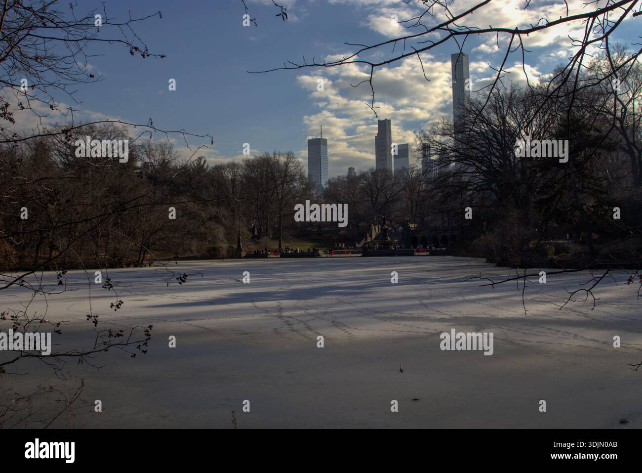 Icy lake surface with distant city skyline and skyscrapers framed by ...
