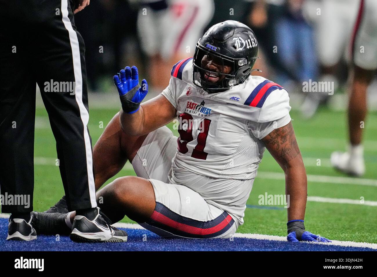 East's Aaron Hall (91), of Duke, smiles after recovering a West fumble ...