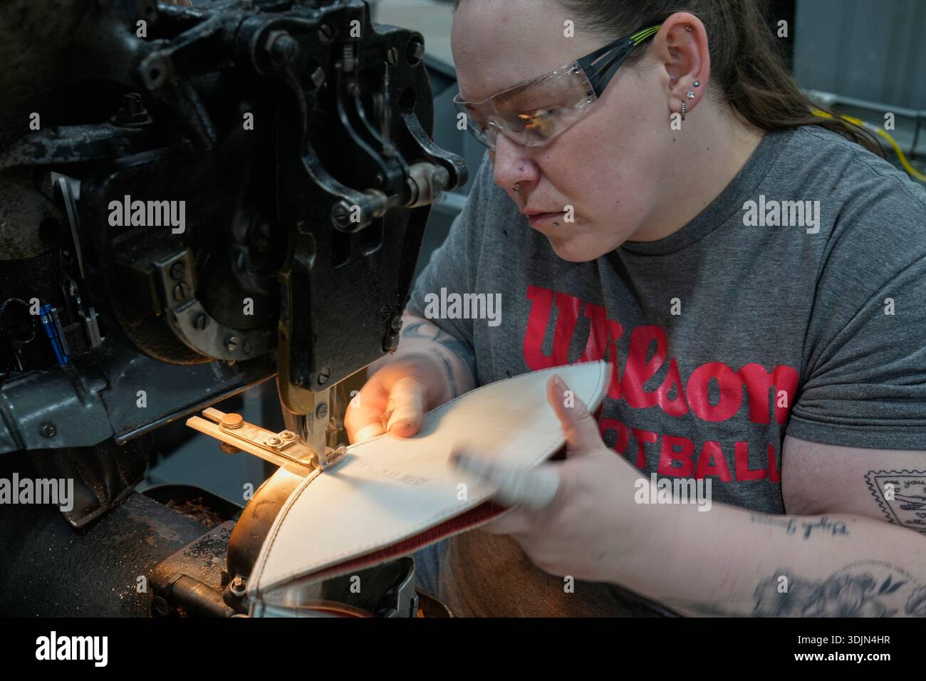 Kaitlin Long, of Alger, Ohio, sews football panels together to make a ...