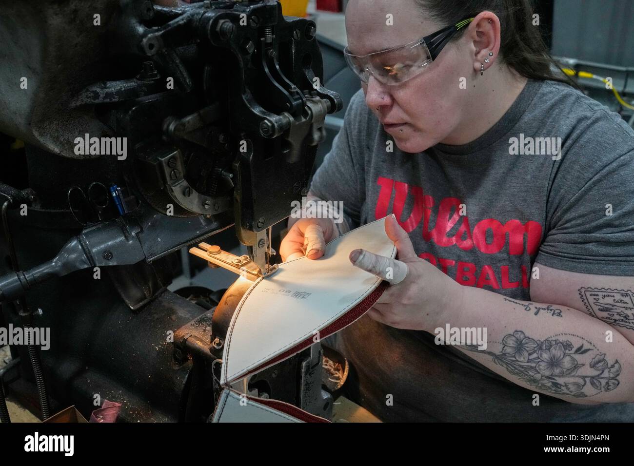 Kaitlin Long, of Alger, Ohio, sews football panels together to make a ...