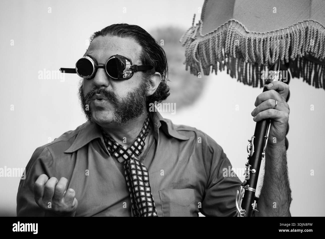 Surreal portrait of a musician fixing a clarinet with burning sparks ...