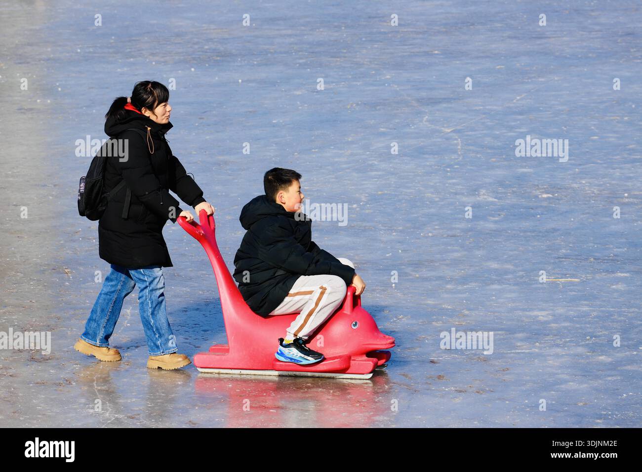 People skate on the ice rink at Beijing Olympic Park, Beijing, China ...