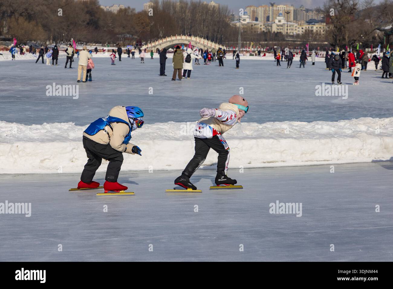 Skating enthusiasts enjoy the public ice rink at a park in Jilin City ...
