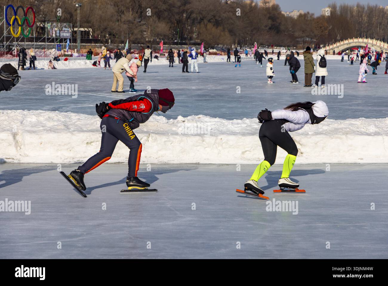 Skating enthusiasts enjoy the public ice rink at a park in Jilin City ...