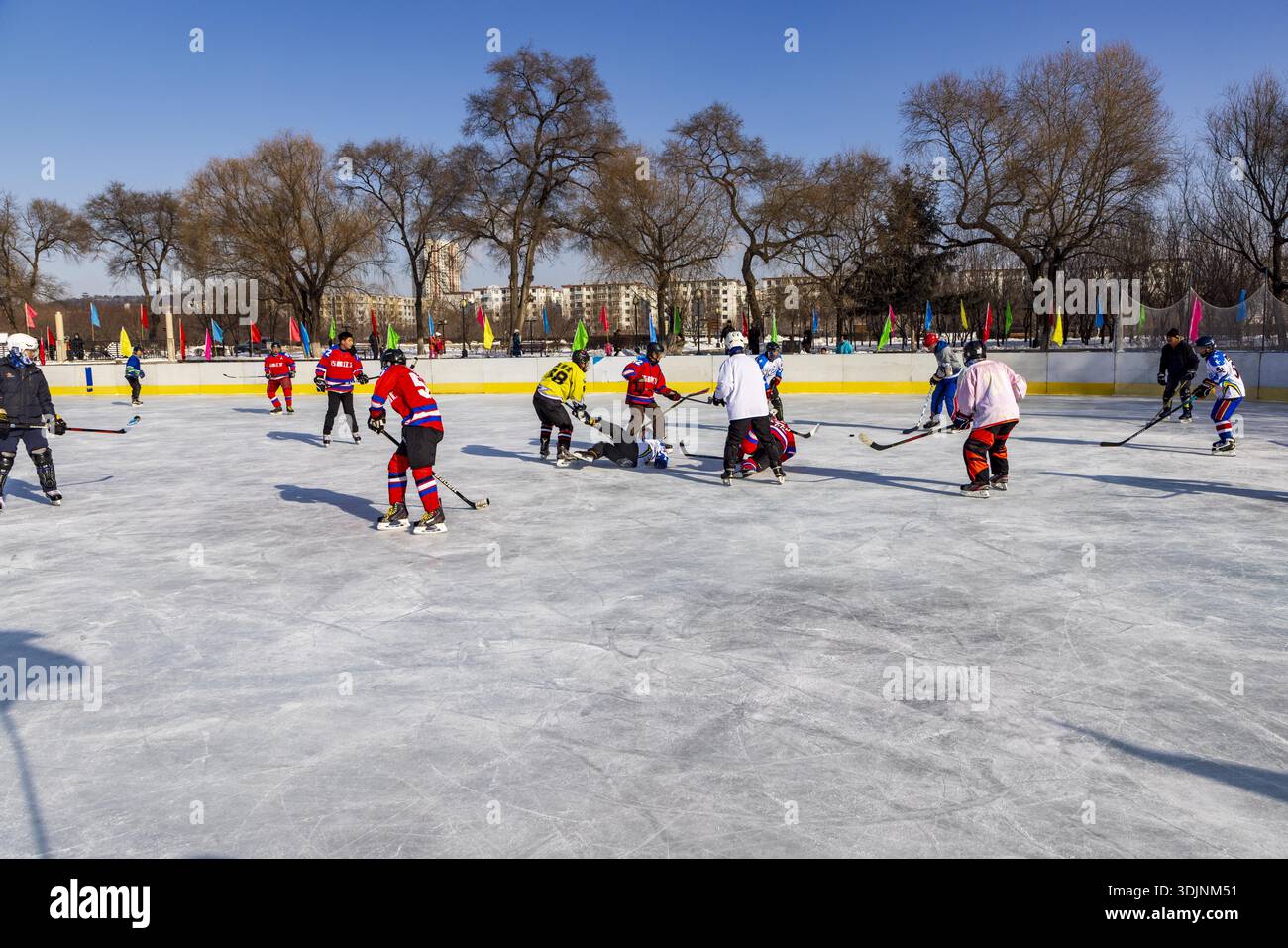 Skating enthusiasts enjoy the public ice rink at a park in Jilin City ...