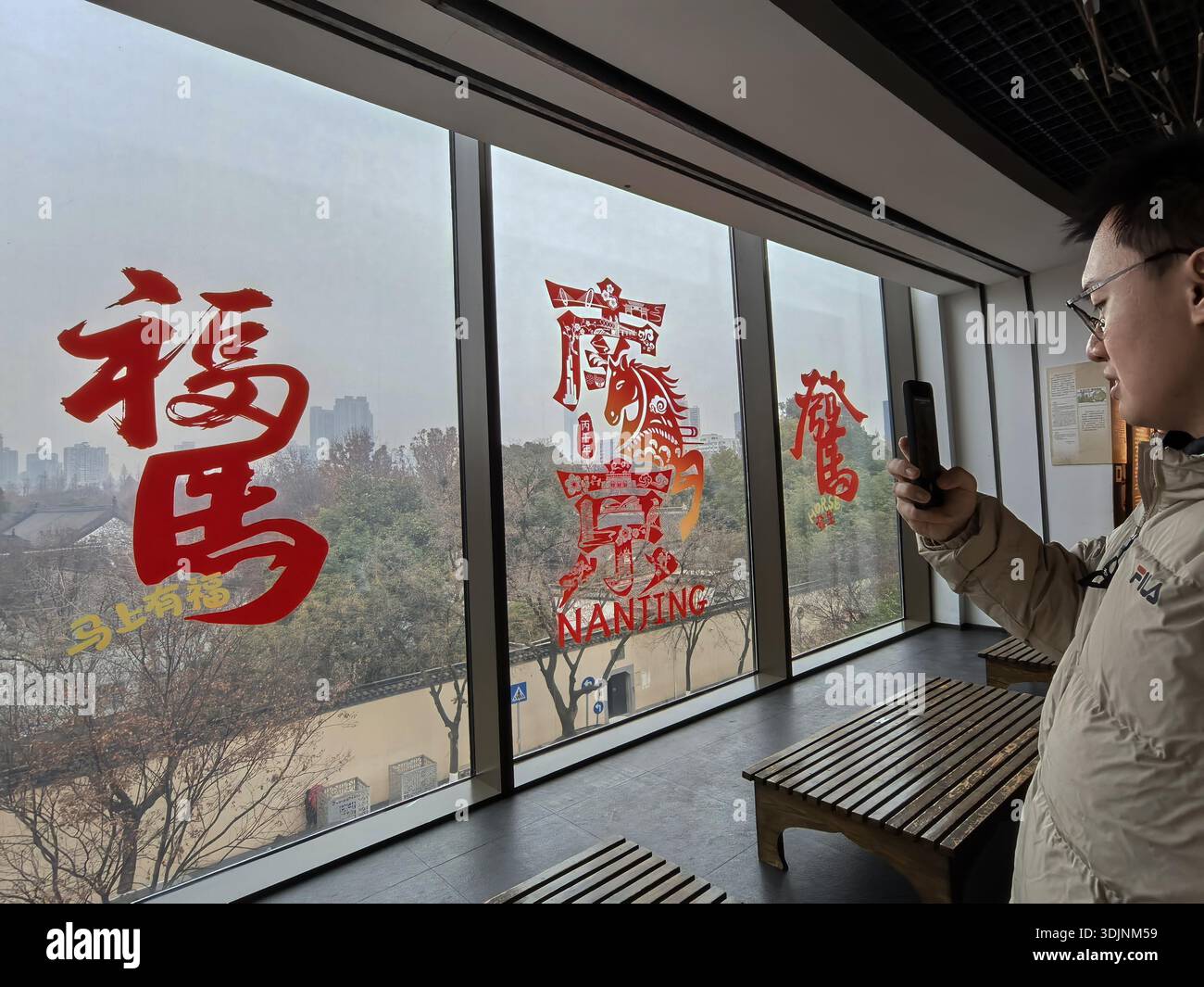 Visitors admire the festive window displays featuring traditional paper ...