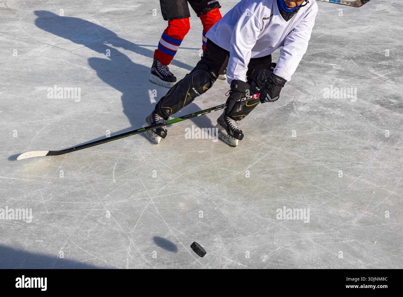 Skating enthusiasts enjoy the public ice rink at a park in Jilin City ...