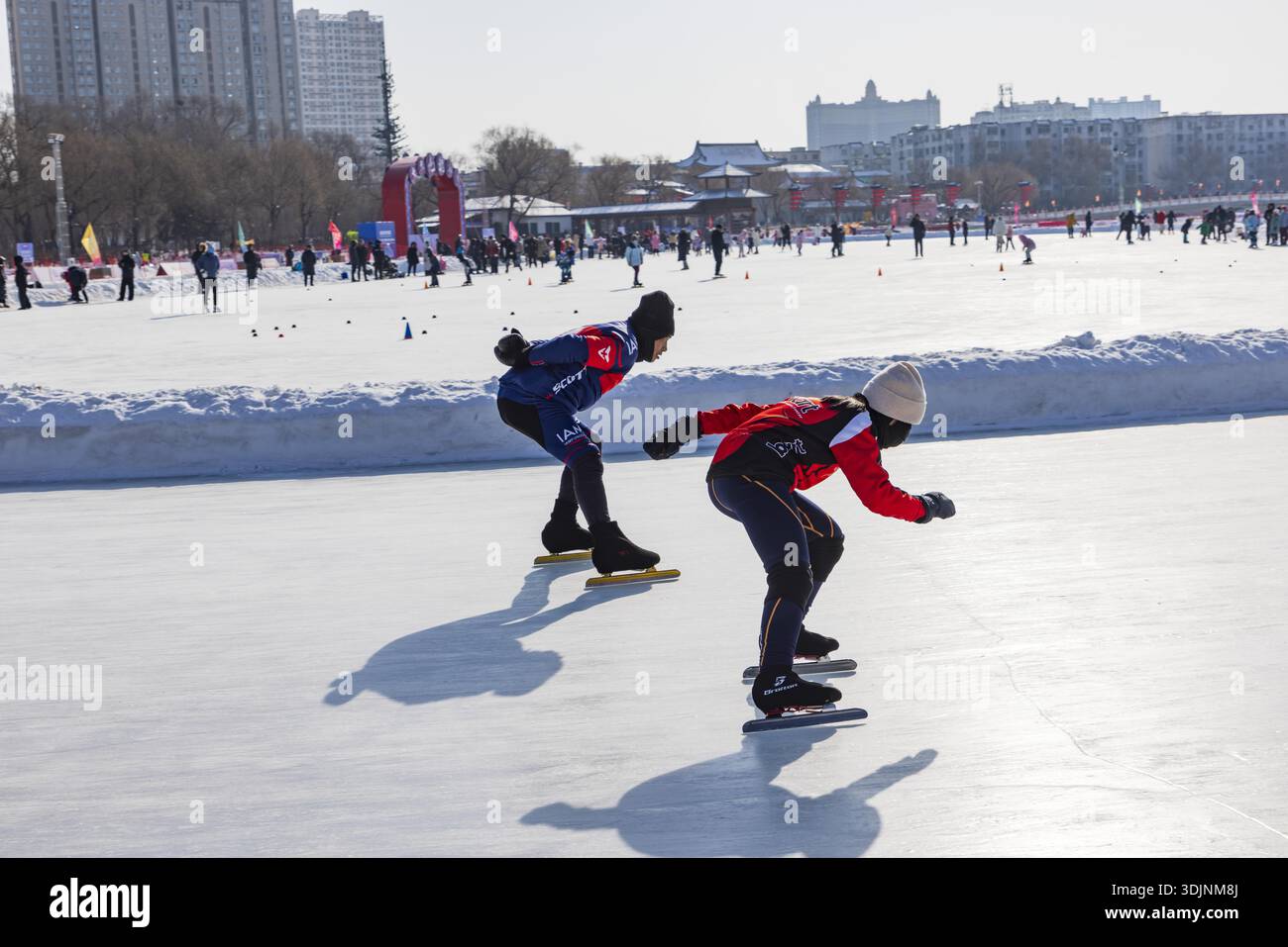Skating enthusiasts enjoy the public ice rink at a park in Jilin City ...