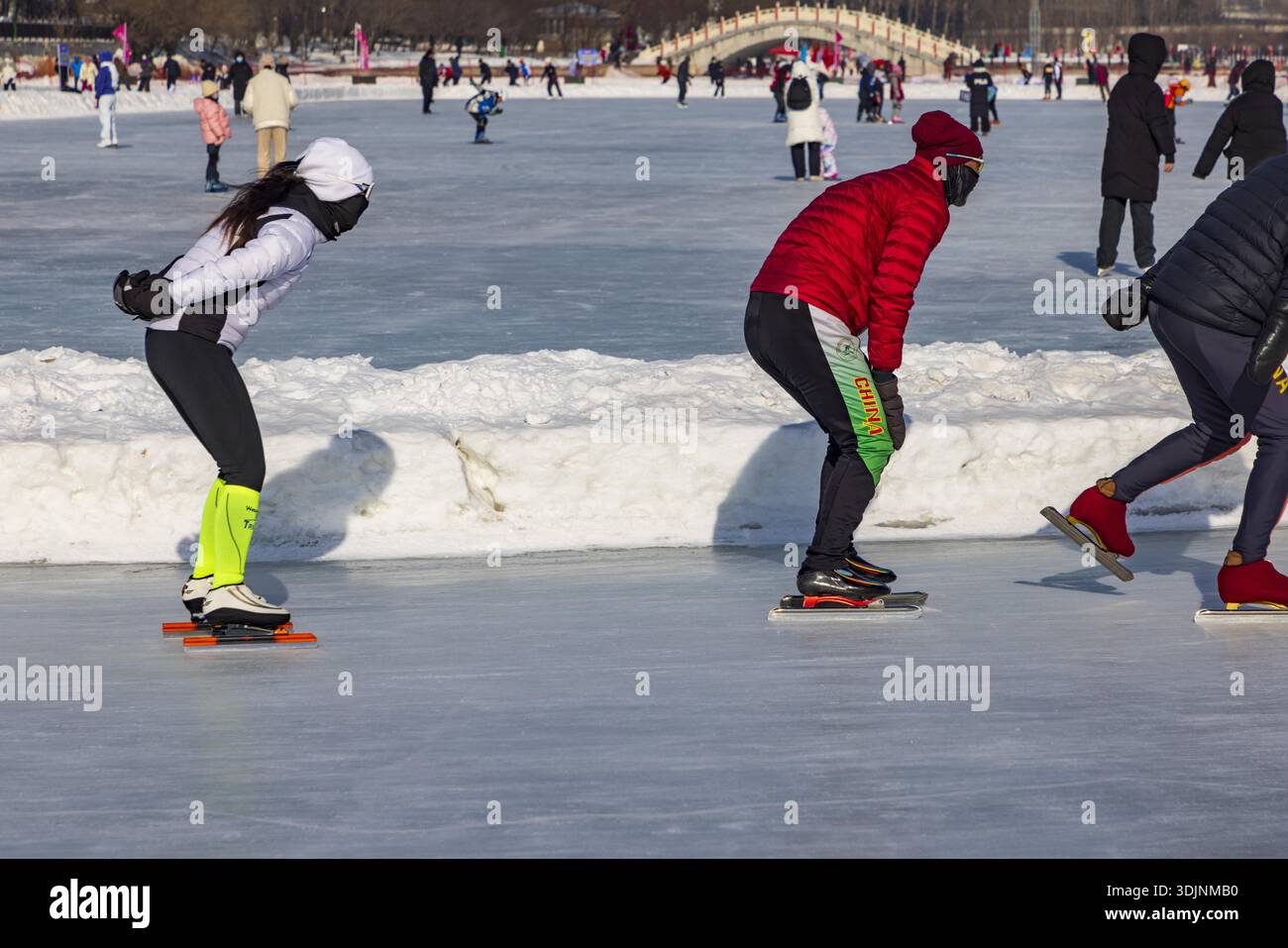 Skating enthusiasts enjoy the public ice rink at a park in Jilin City ...